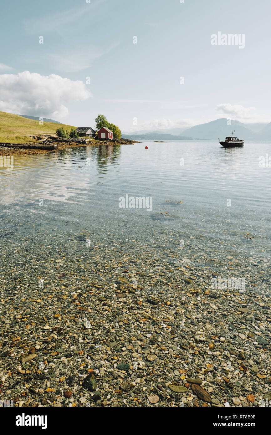 The small island of Omaholmen on a beautiful summers day in Hardangerfjord Hordaland, Norway ...