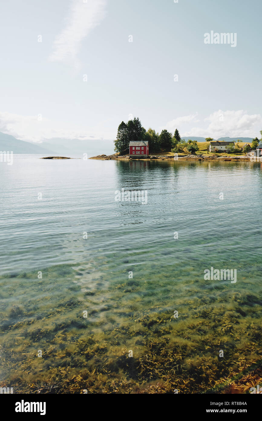 The small island of Omaholmen on a beautiful summers day in Hardangerfjord Hordaland, Norway ...