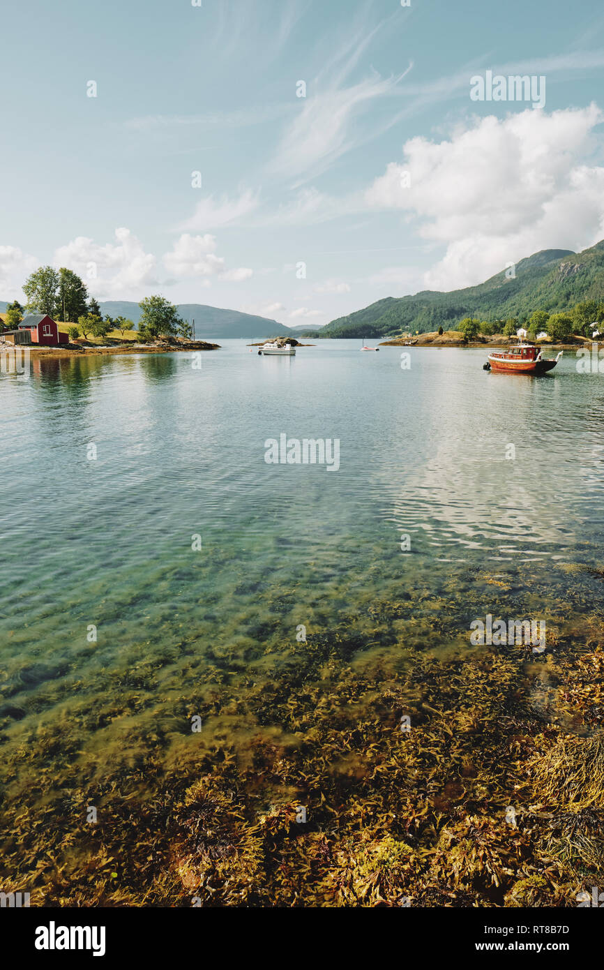 The small island of Omaholmen on a beautiful summers day in Hardangerfjord Hordaland, Norway ...