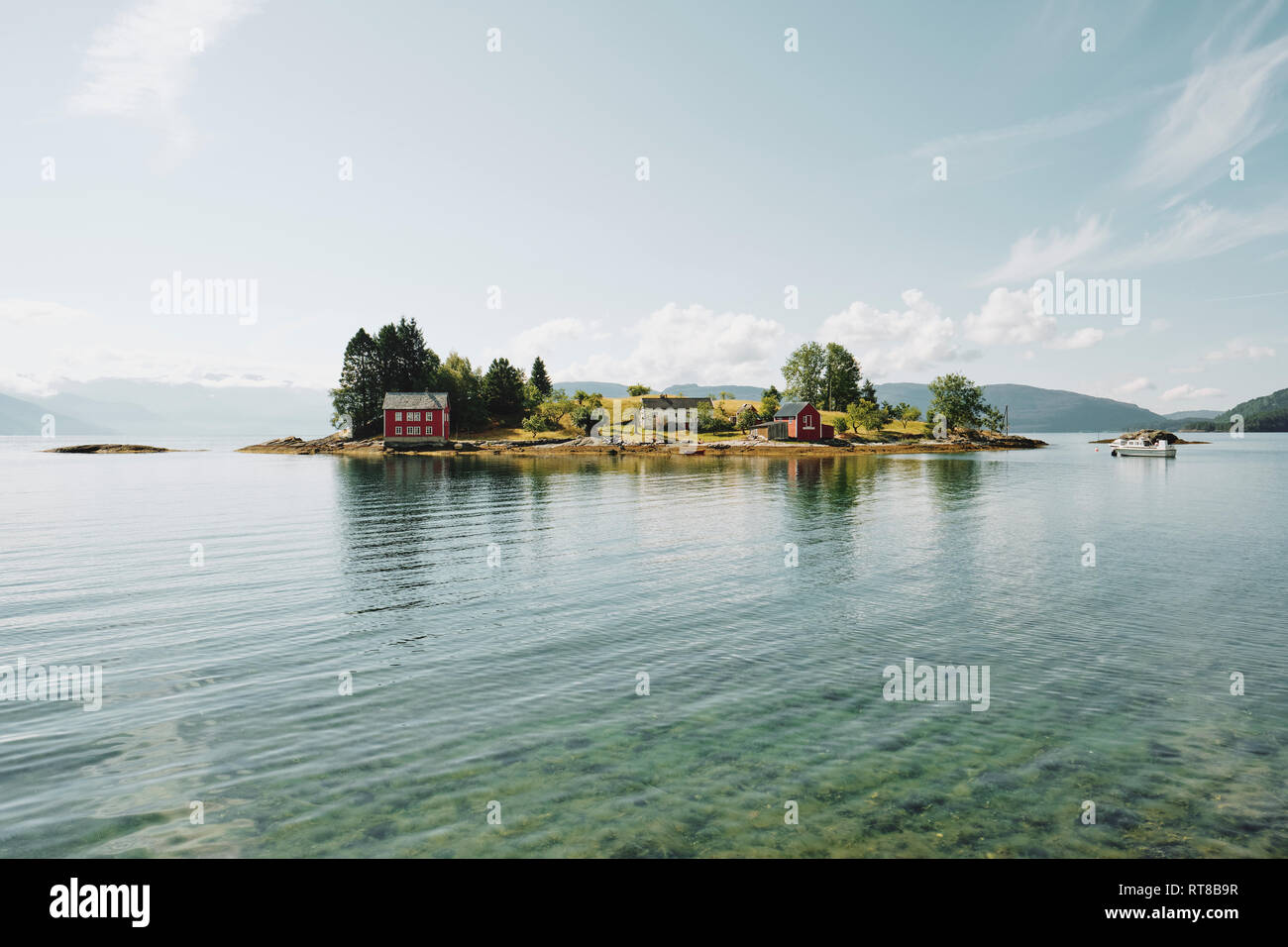 The small island of Omaholmen on a beautiful summers day in Hardangerfjord Hordaland, Norway ...