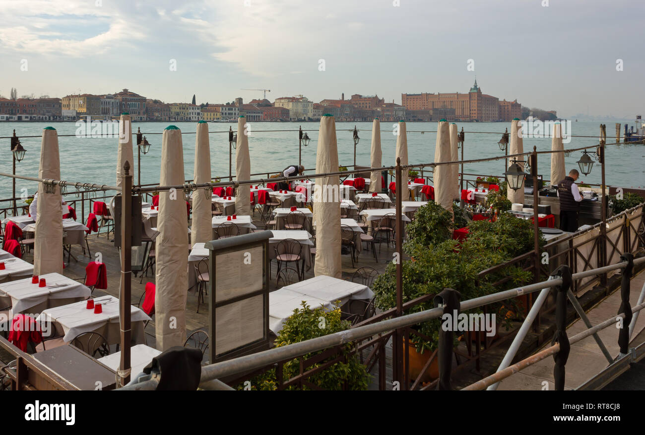 VENICE, Italy - January 12, 2019: Waiters at work in an elegant ...