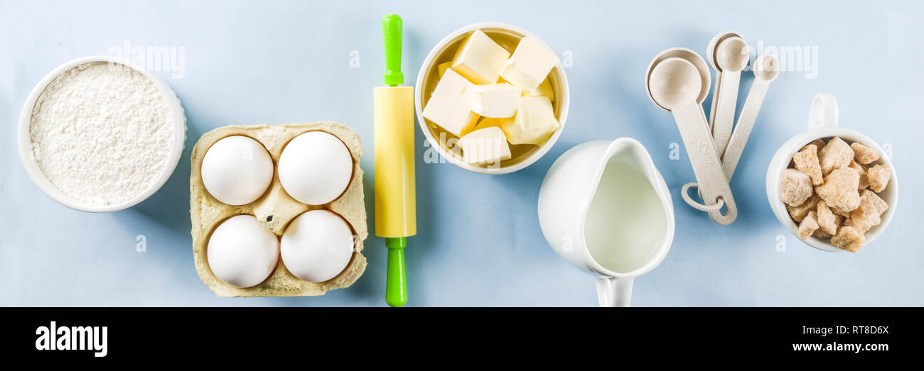 Baking ingredients and tools on trendy bright blue background - flour ...