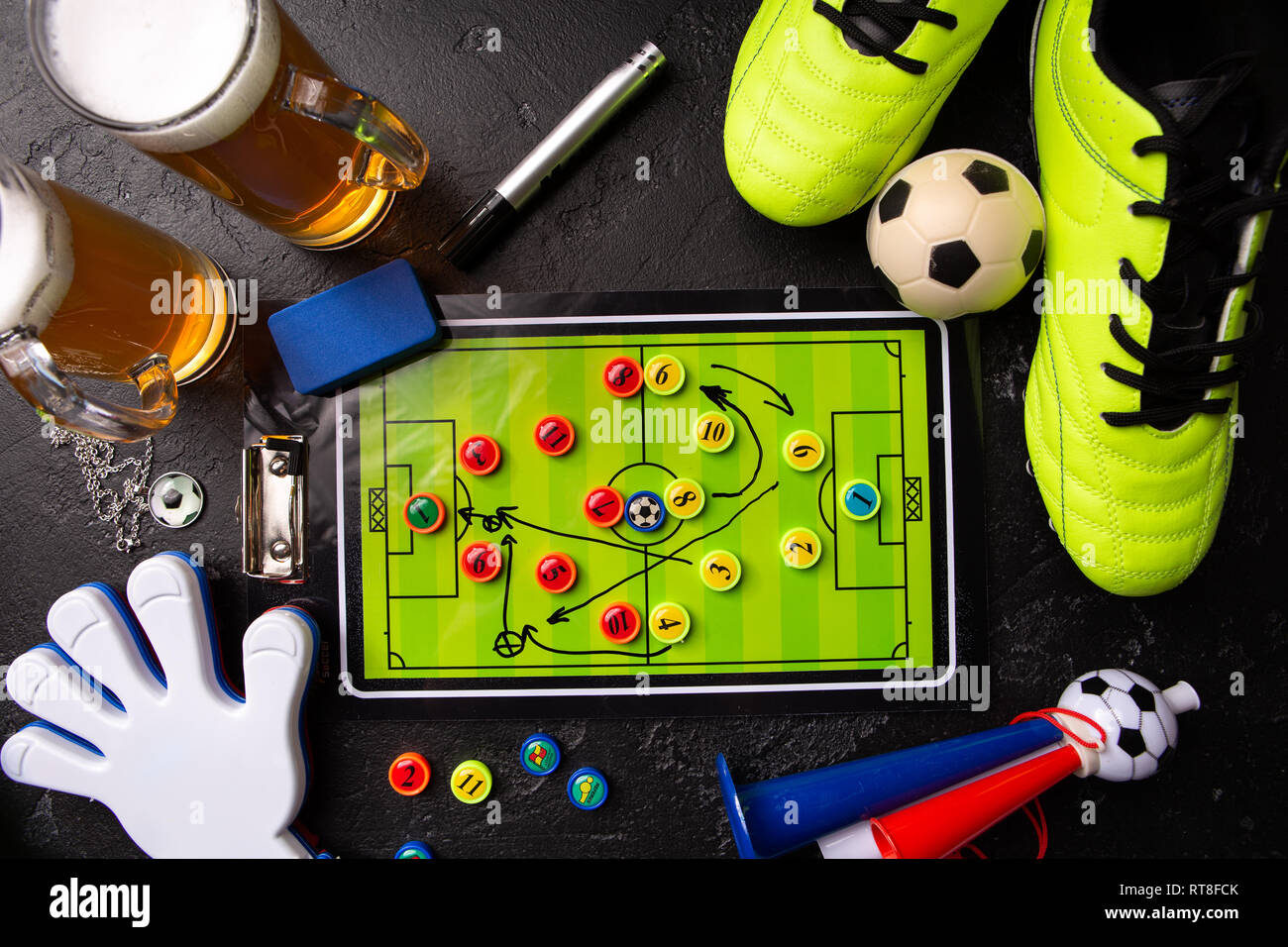 Photo on top of two mugs of foam beer, table football, ball, football ...