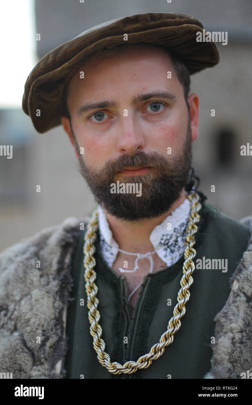 Portrait of a young Tudor man wearing authentic Tudor clothes poses ...