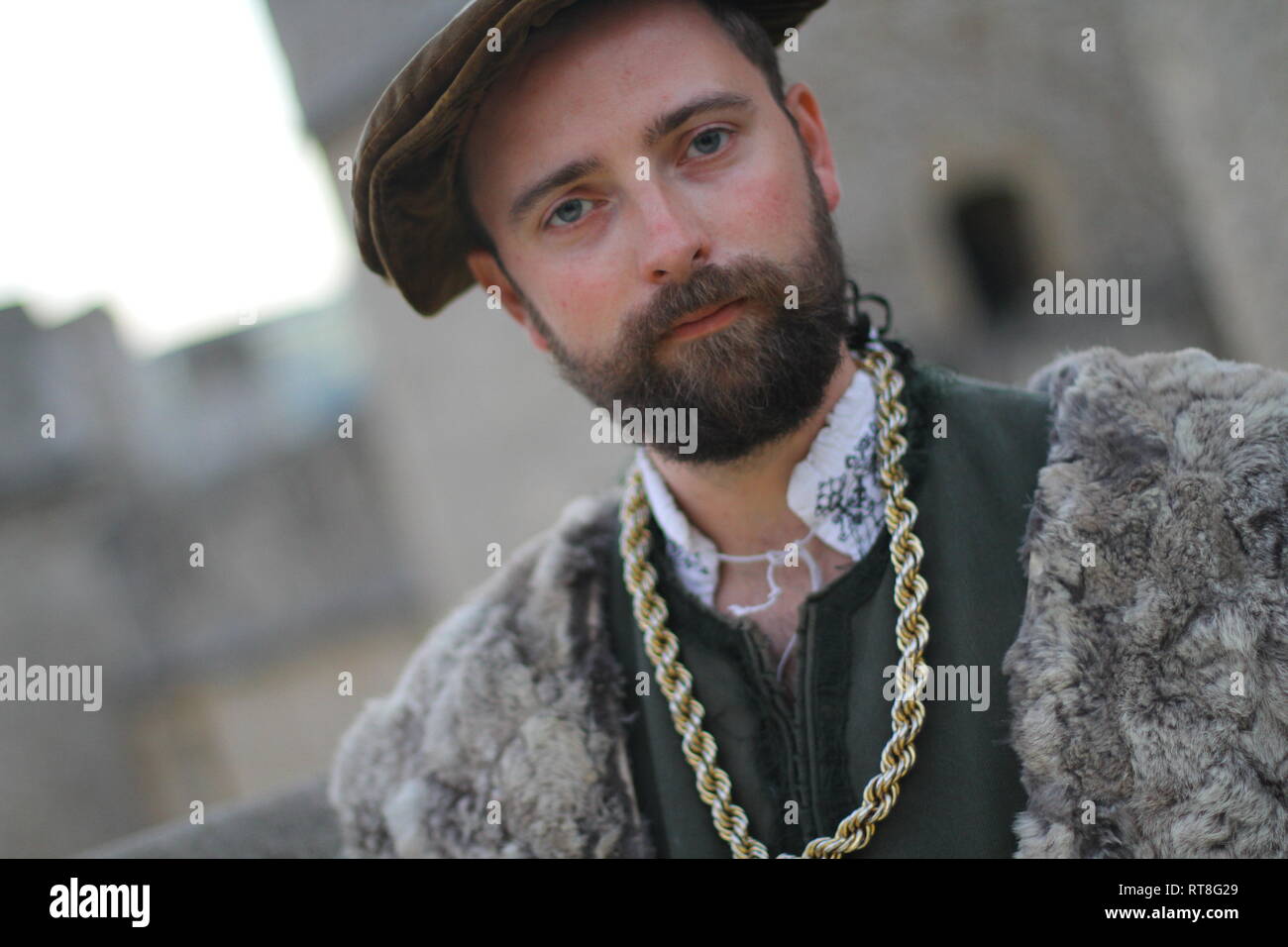 Portrait of a young Tudor man wearing authentic Tudor clothes poses ...