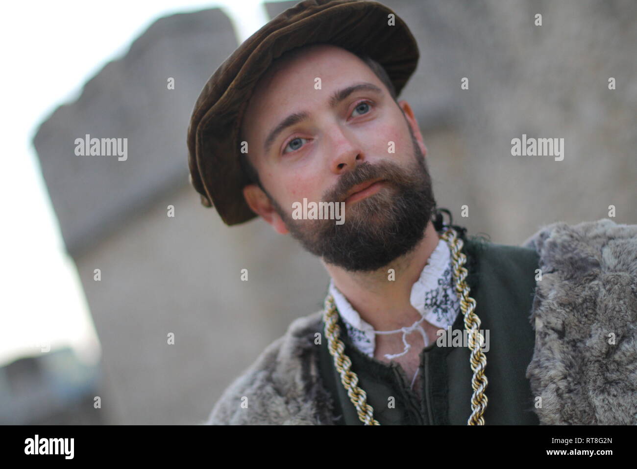 Portrait of a young Tudor man wearing authentic Tudor clothes poses ...