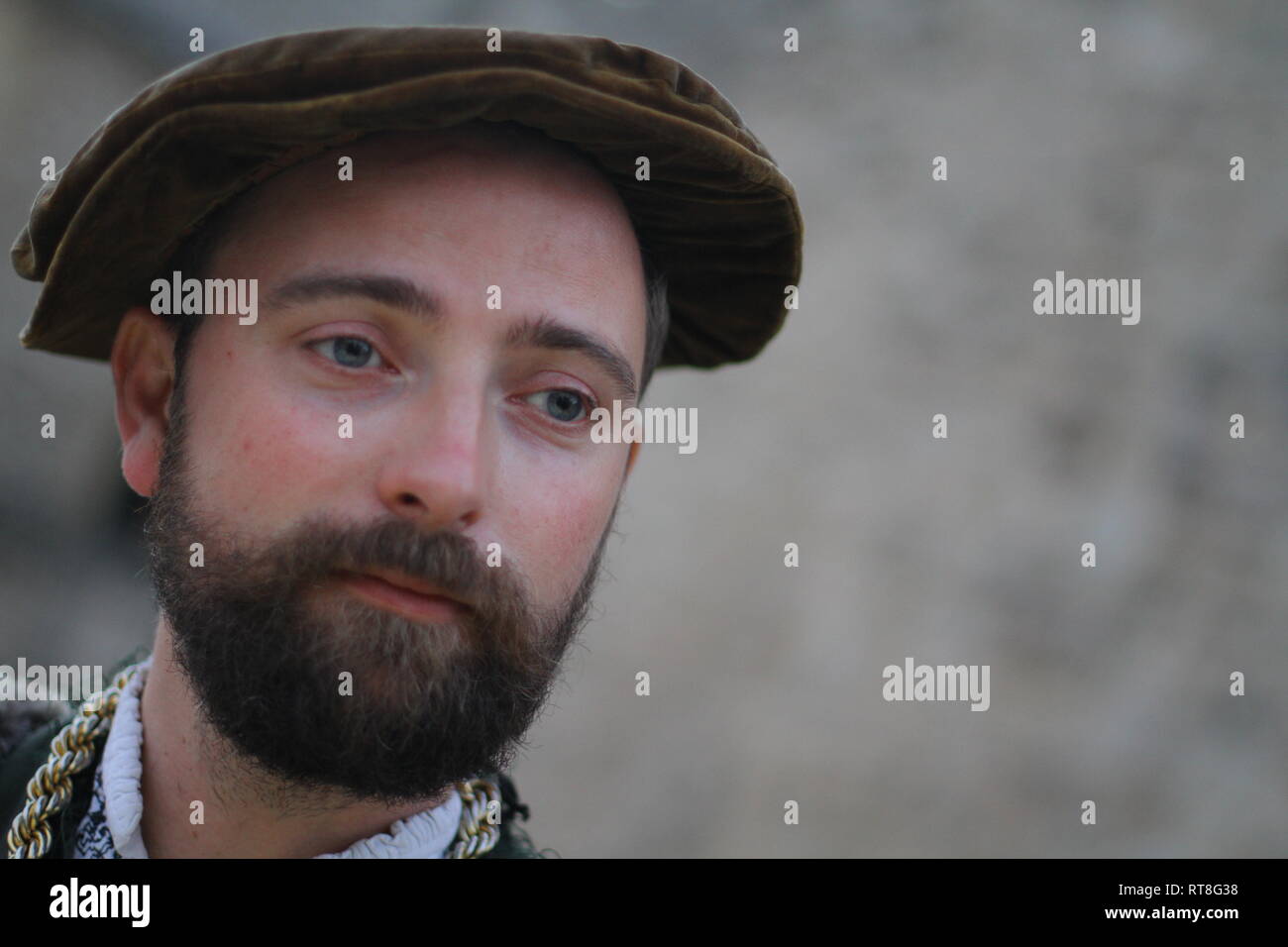 Portrait of a young Tudor man wearing authentic Tudor clothes poses ...