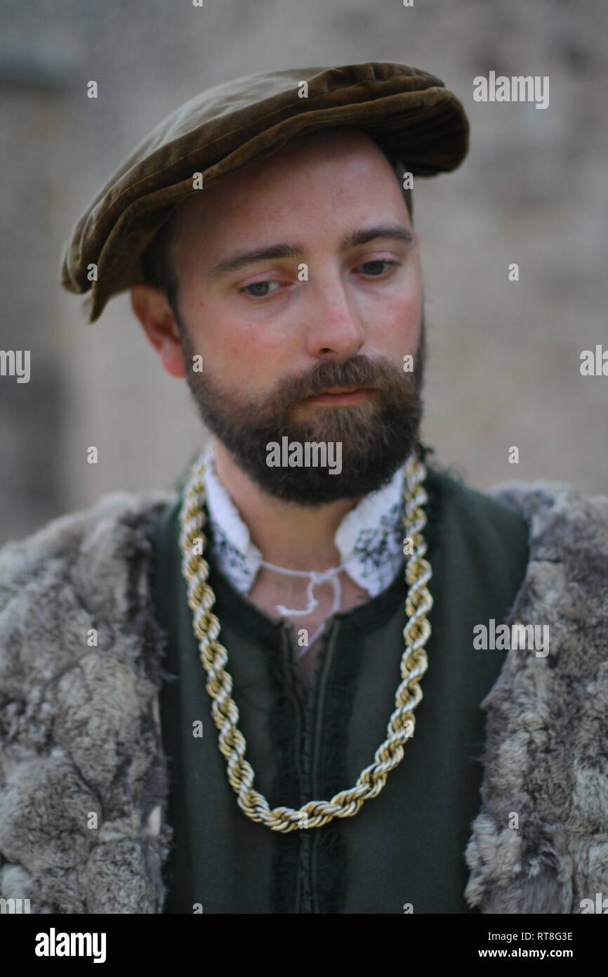 Portrait of a young Tudor man wearing authentic Tudor clothes poses ...