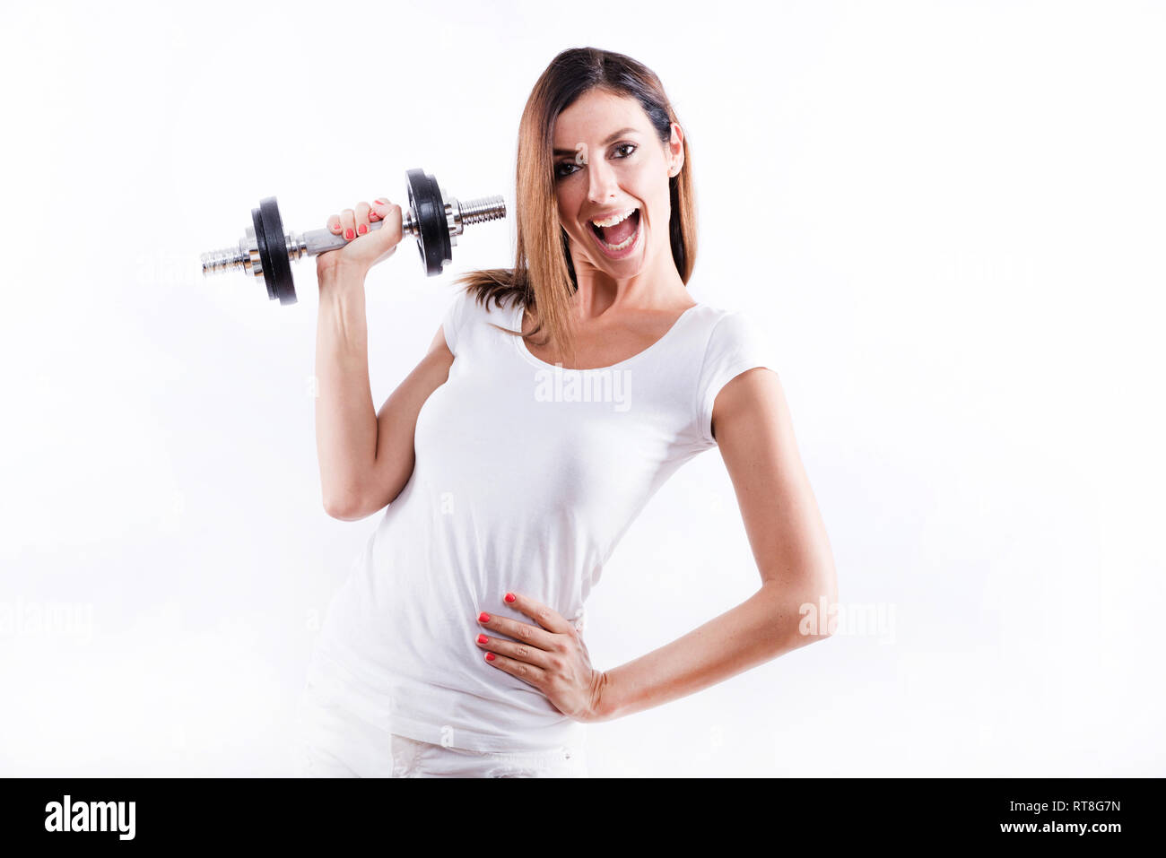 A beautiful young woman lifting weight and feeling happy Stock Photo ...