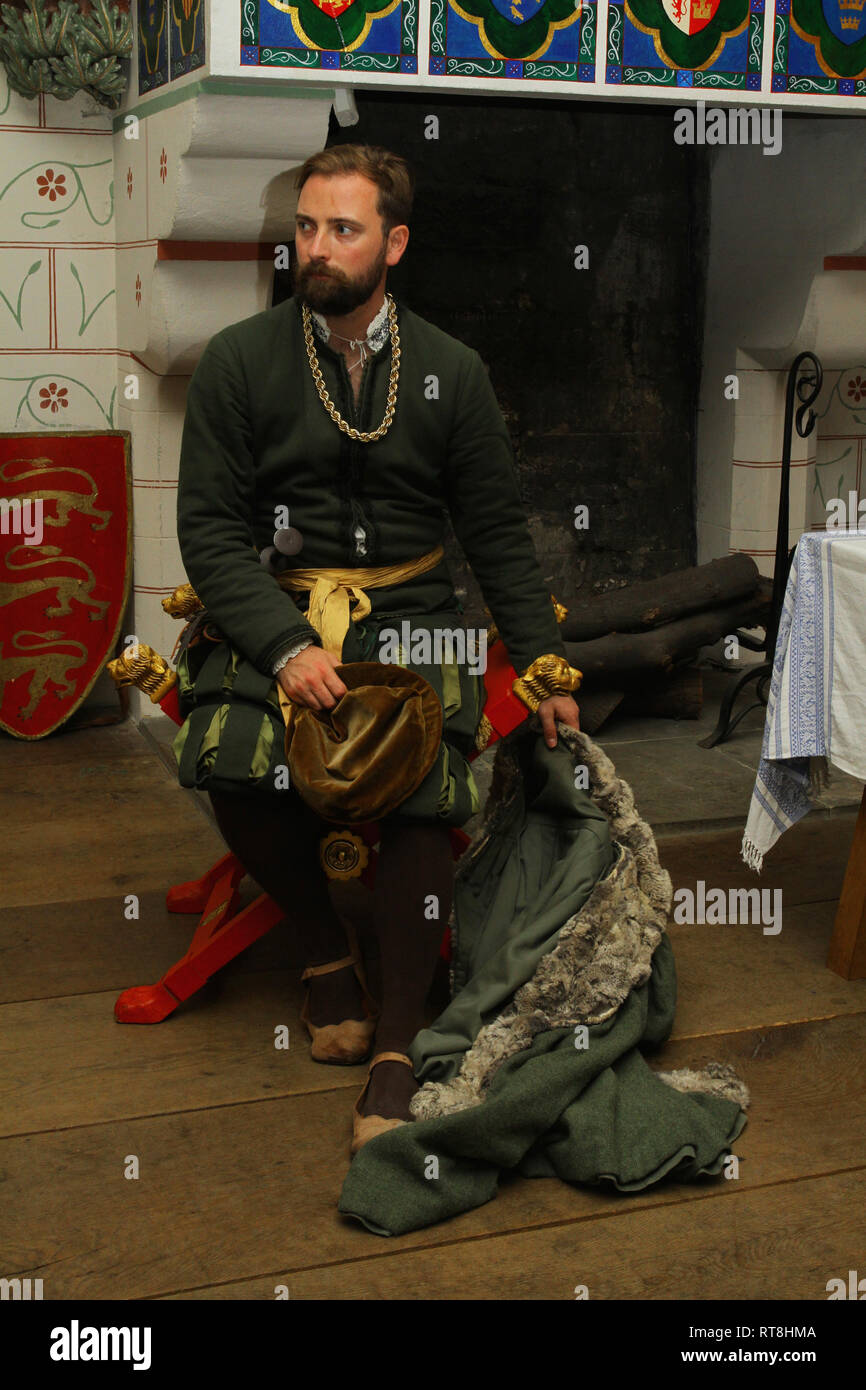 A well dressed Tudor man in front of a large fireplace at The Tower of ...