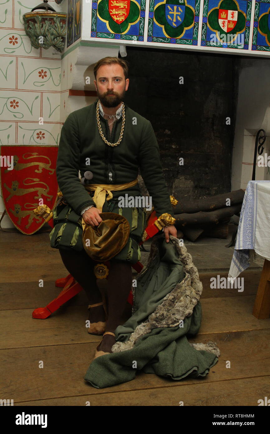 A well dressed Tudor man in front of a large fireplace at The Tower of ...