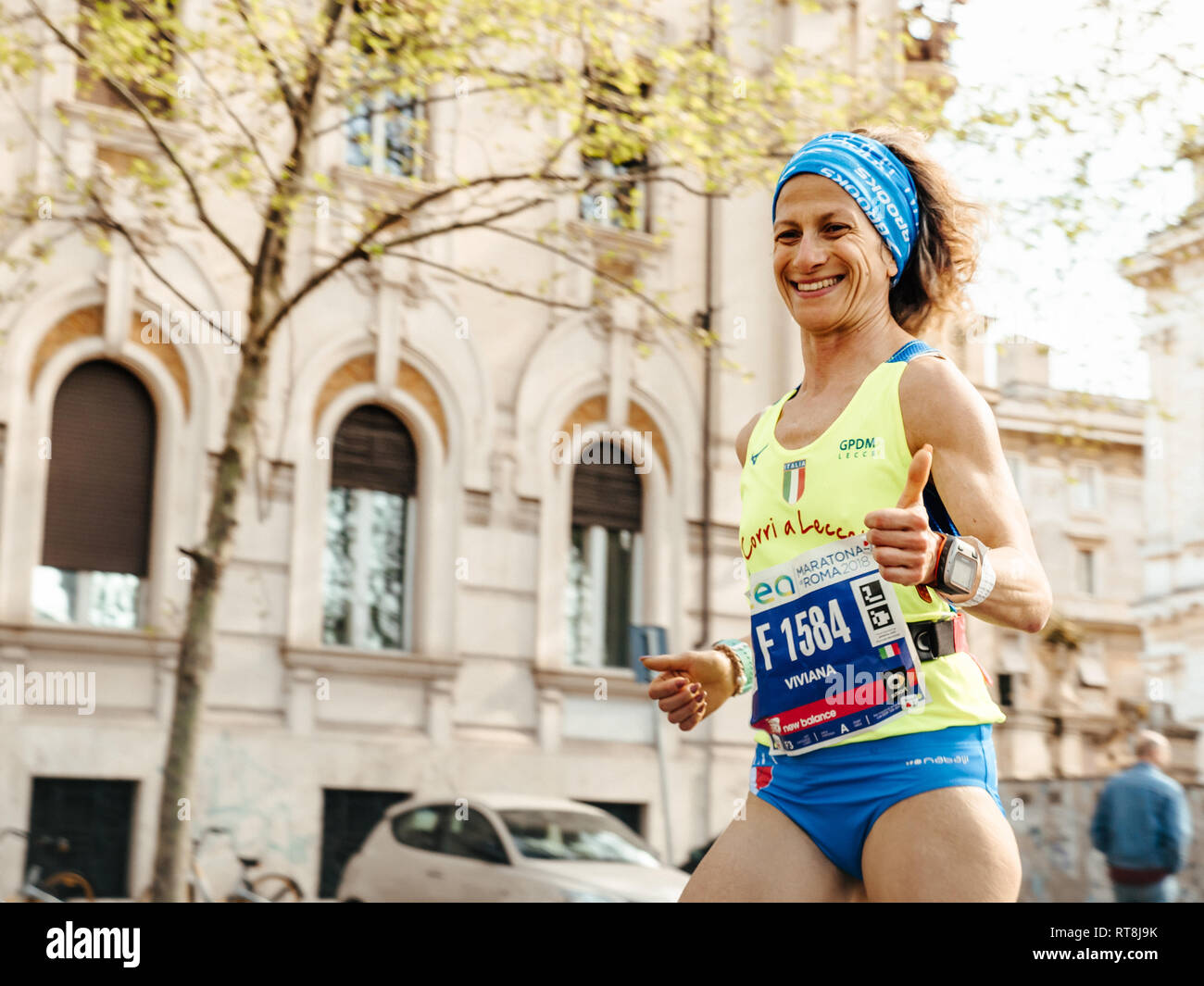 Rome, Italy - April 8, 2018: woman runner run and smiles and shows ...