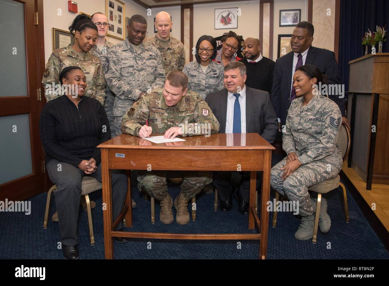 Col. Chad Ellsworth, center, installation commander, signs an African ...