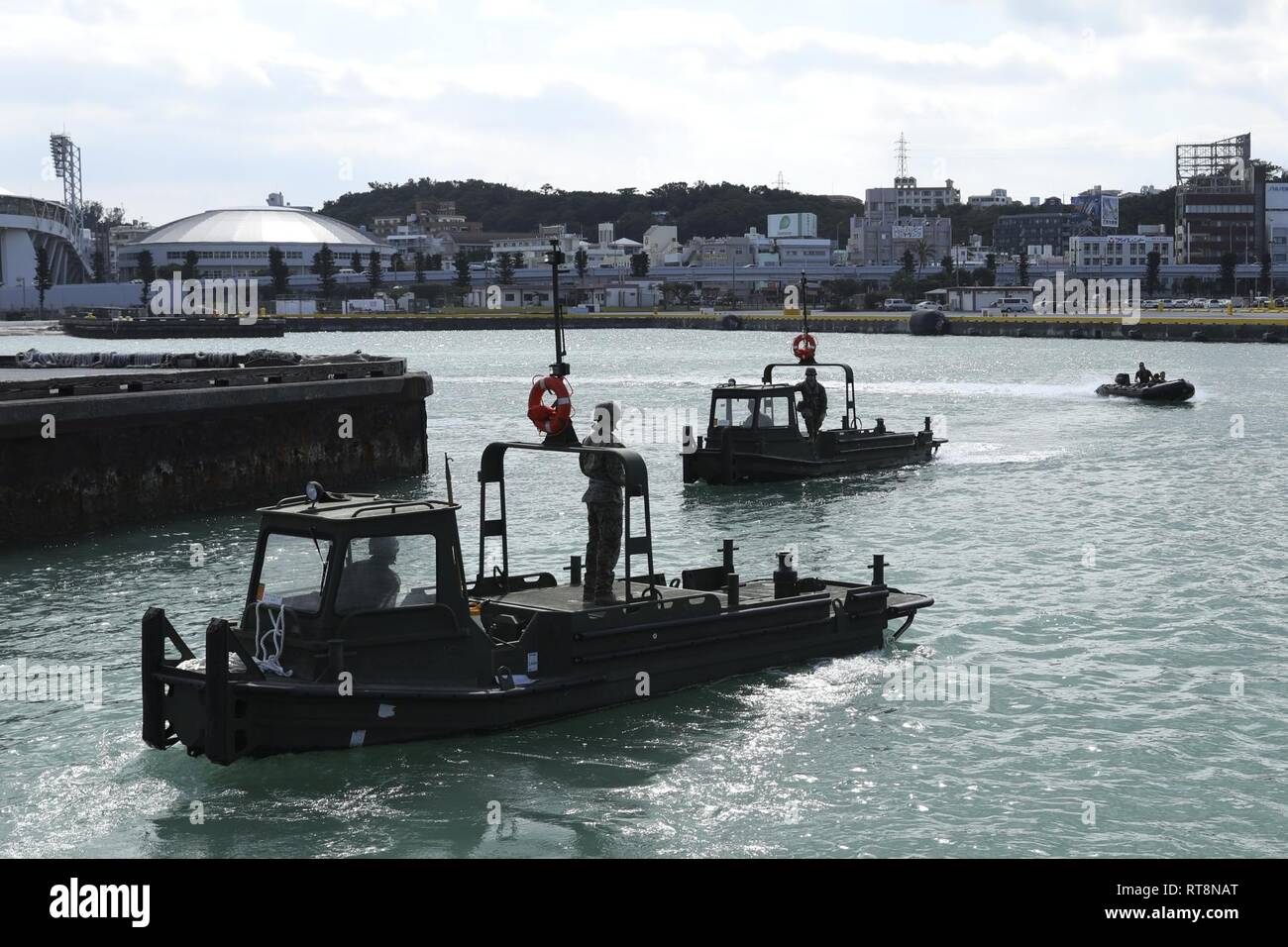 Combat engineers navigate across the water in bridge erection boats ...