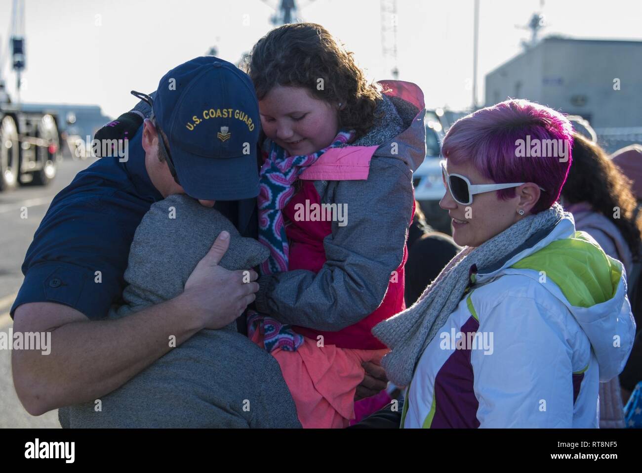 A Coast Guard Cutter Valiant crew member embraces his family Jan. 29 ...