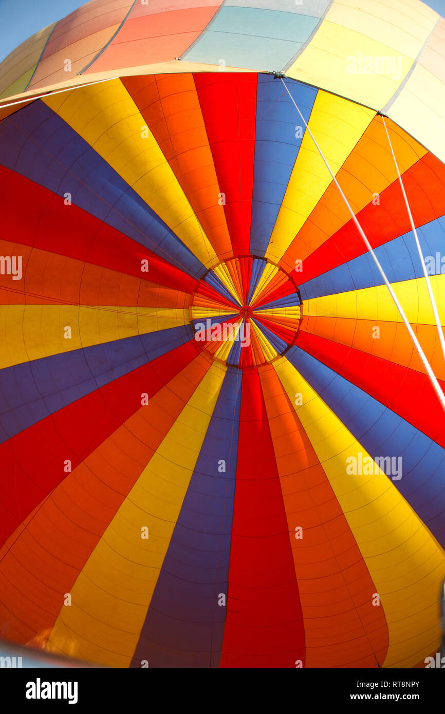 Brightly coloured view of balloon canopy in flight, Masai Mara Kenya ...