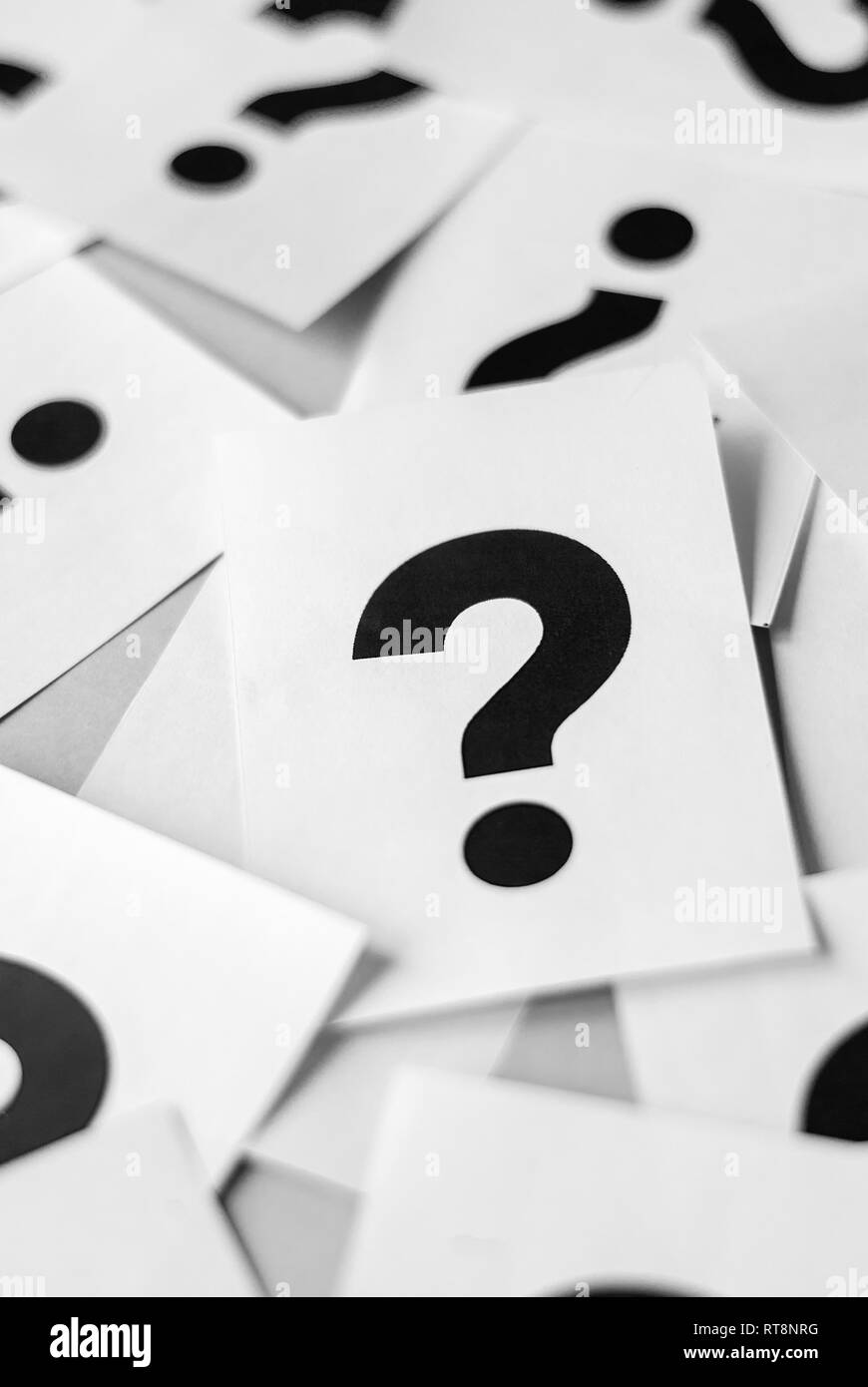Pile of white cards with black question marks in close-up, full frame ...