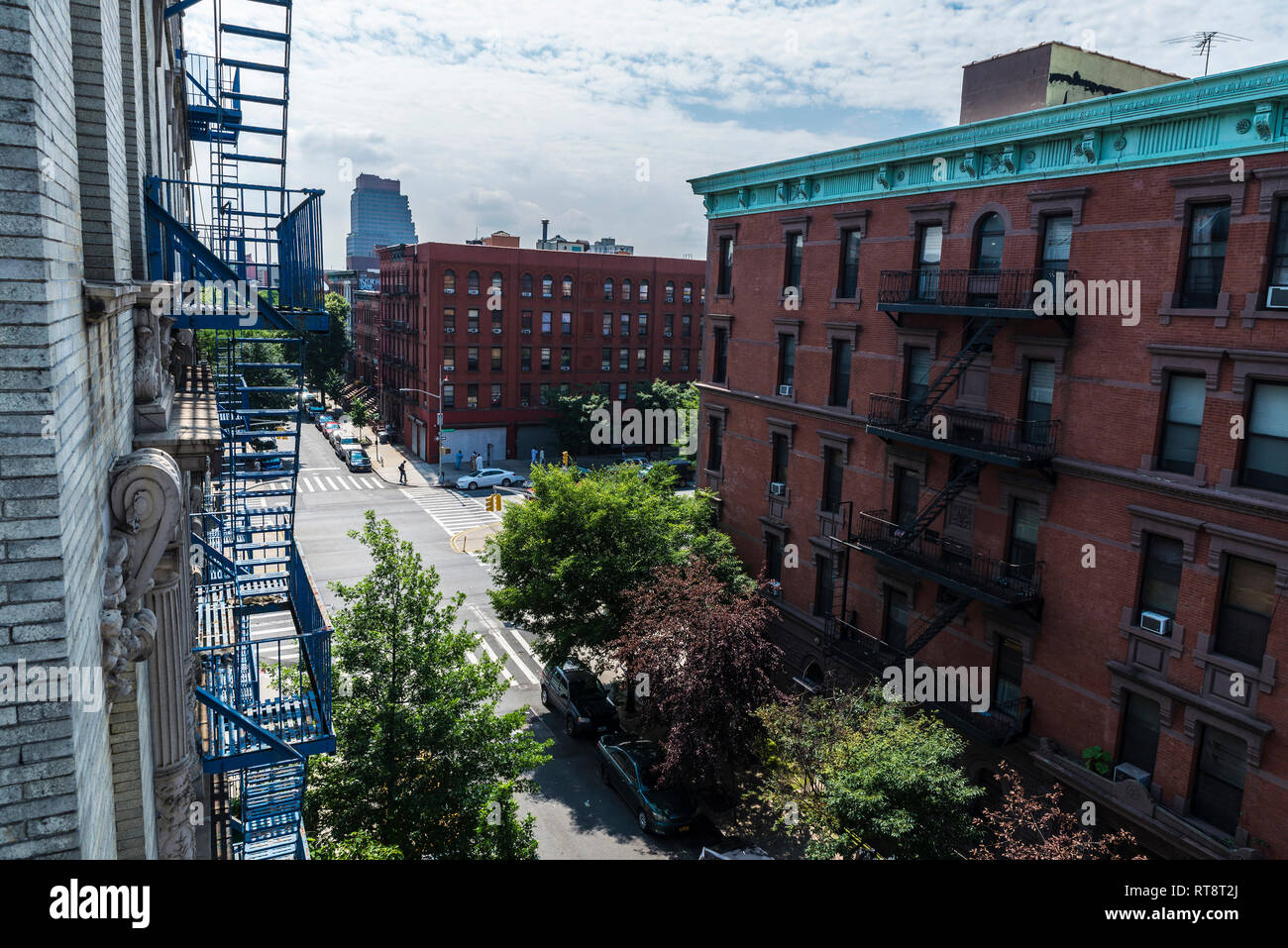 Overview of a street with its old typical houses and people around in ...