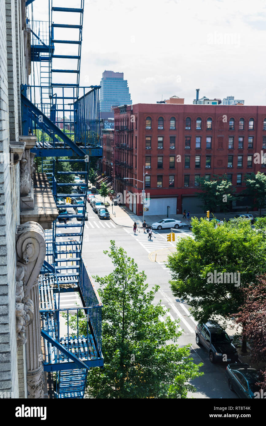 Overview of a street with its old typical houses and people around in ...