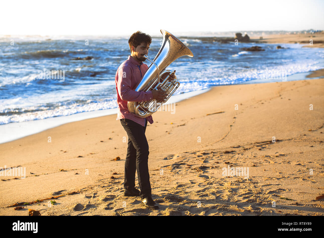 Musician playing the Tuba on the Ocean coast Stock Photo - Alamy