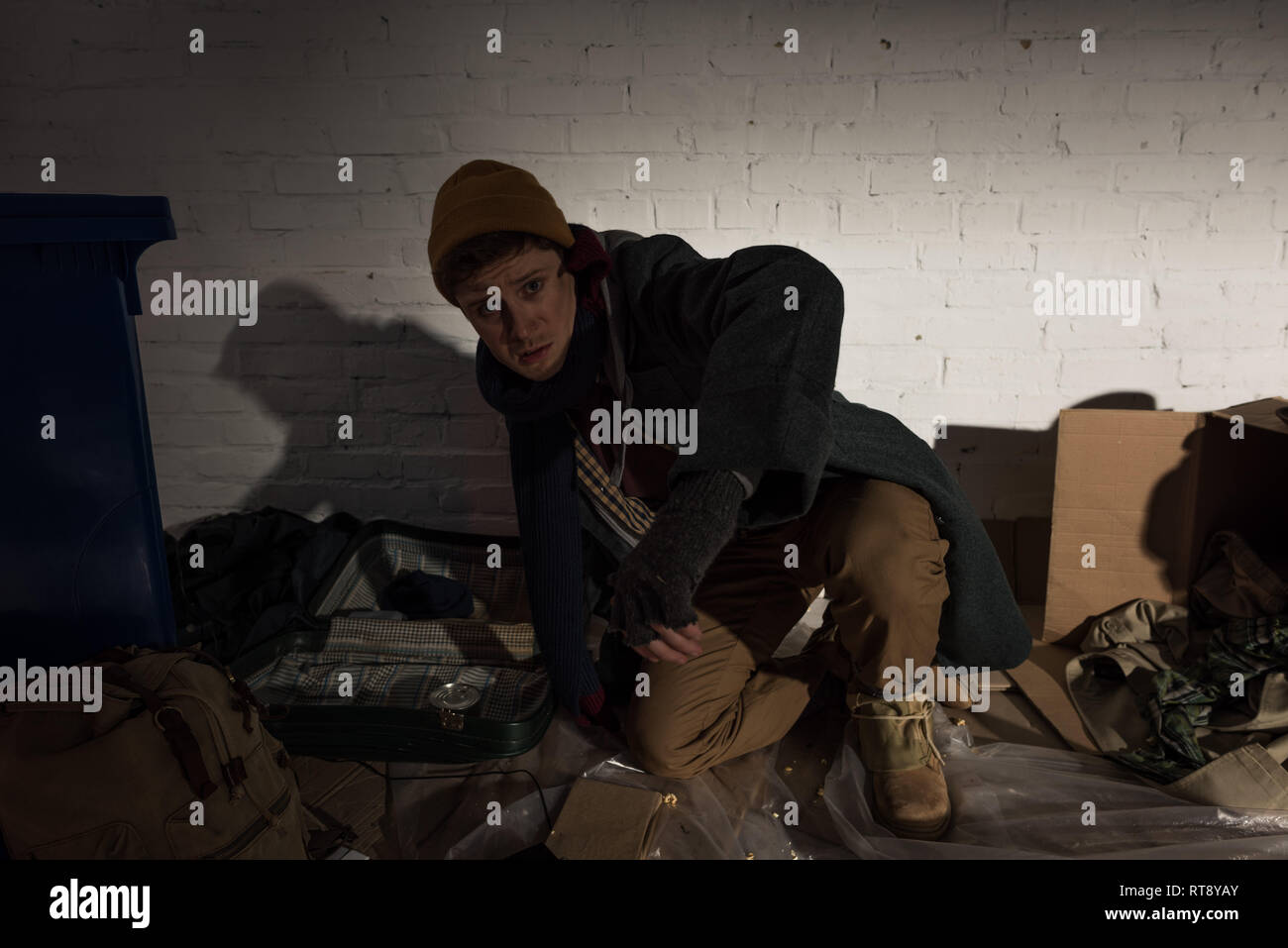 drunk angry homeless man standing on knee on rubbish dump Stock Photo ...