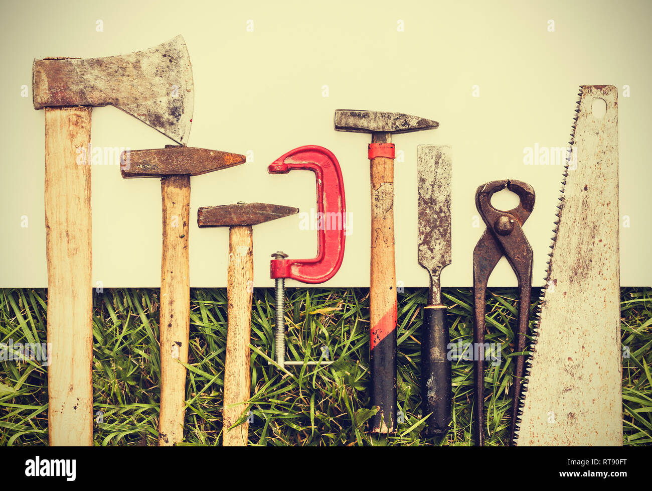 Set of vintage hand construction tools on a white wooden background ...