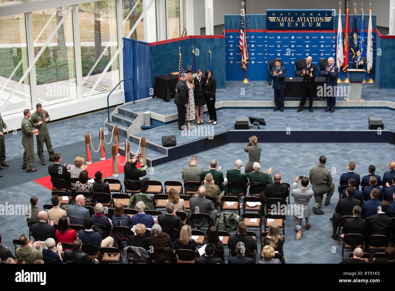 A newly graduated Naval Flight Officer poses for a photo with family ...