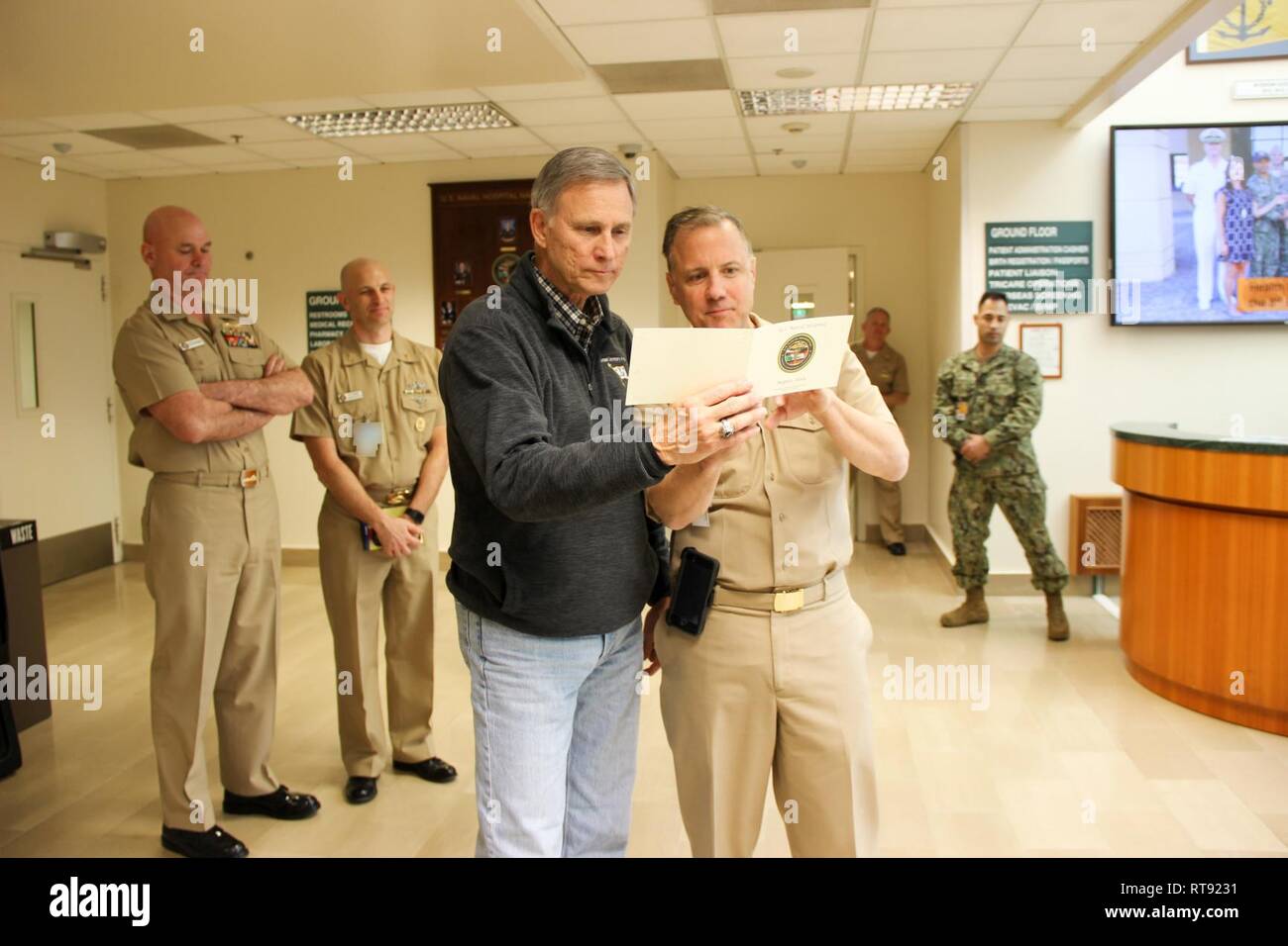 Commanding Officer Capt. Richard Knittig (right) presents Assistant ...