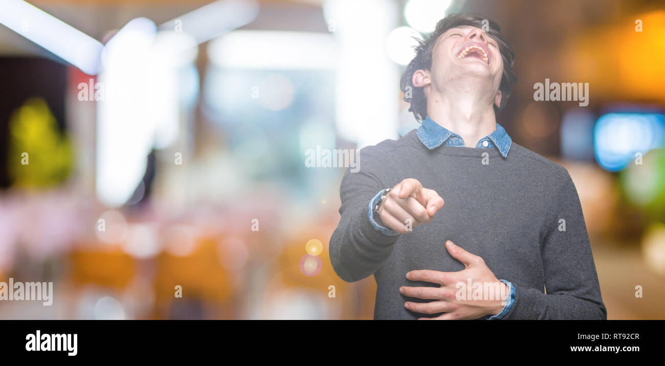 Young handsome elegant man over isolated background Laughing of you ...