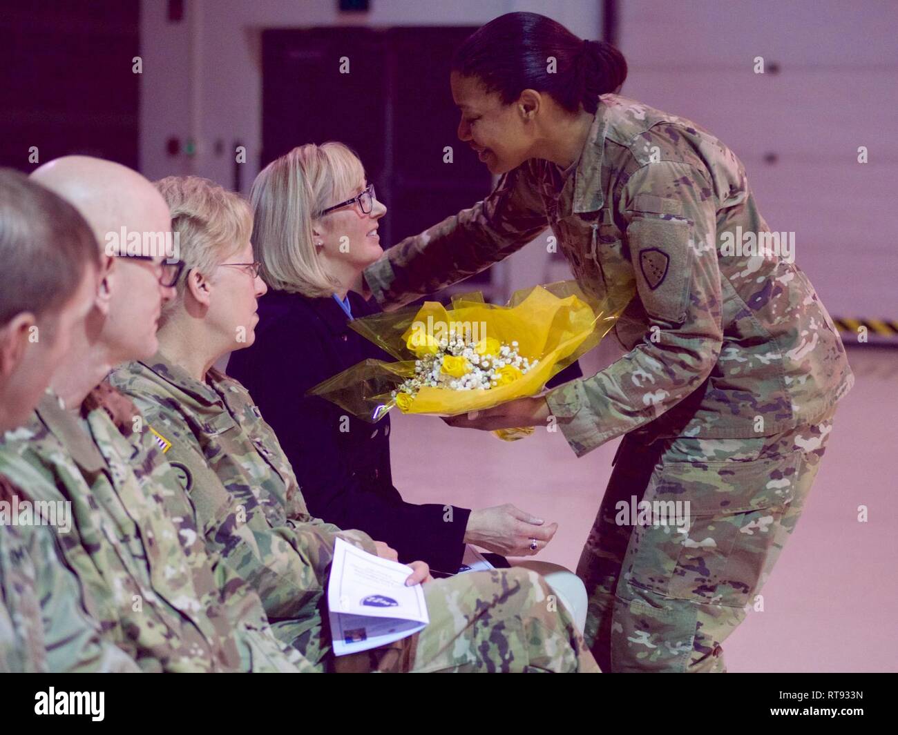 Alaska Army National Guard Sgt. 1st Class Angela Horn presents flowers ...