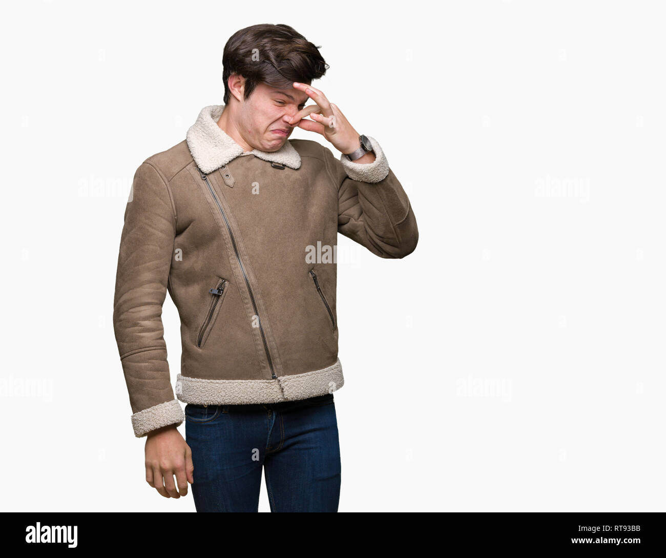 Young handsome man wearing winter coat over isolated background ...