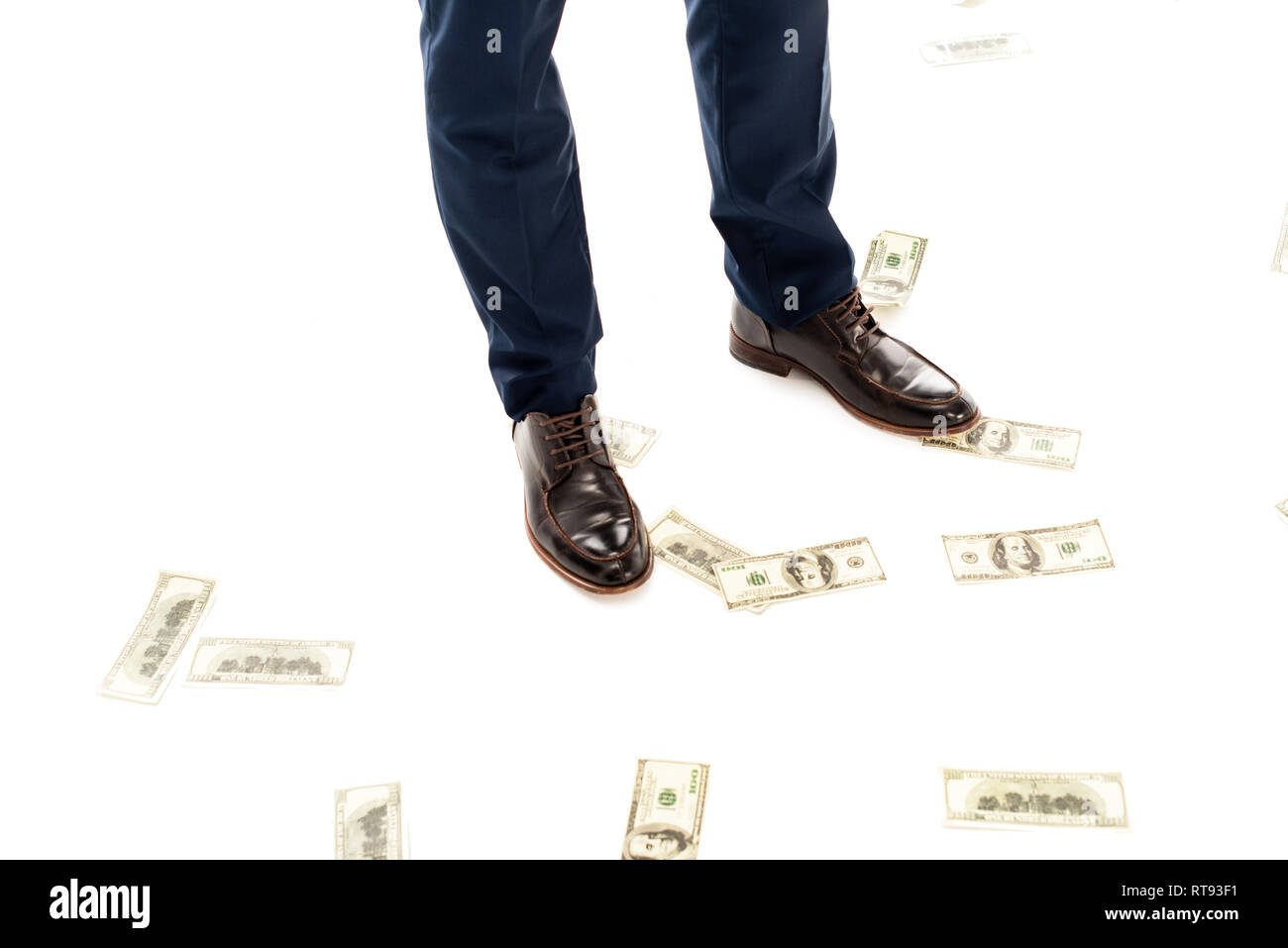 partial view of businessman with money under feet, isolated on white ...