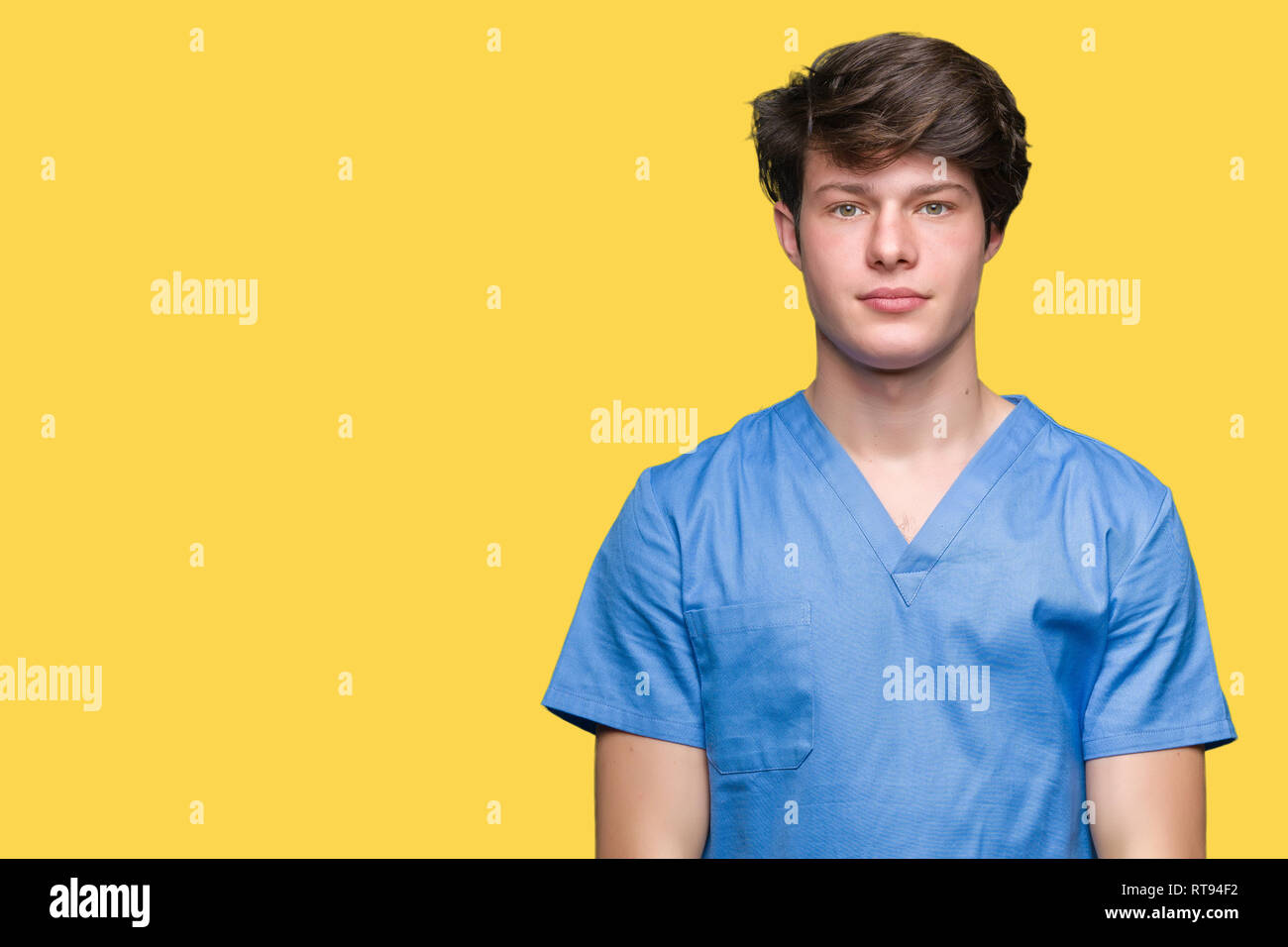 Young doctor wearing medical uniform over isolated background with ...