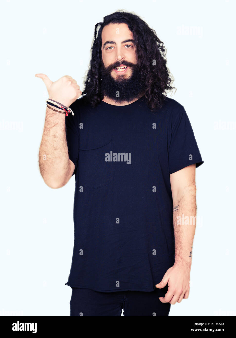Young man with long hair and beard wearing heavy metal black outfit ...