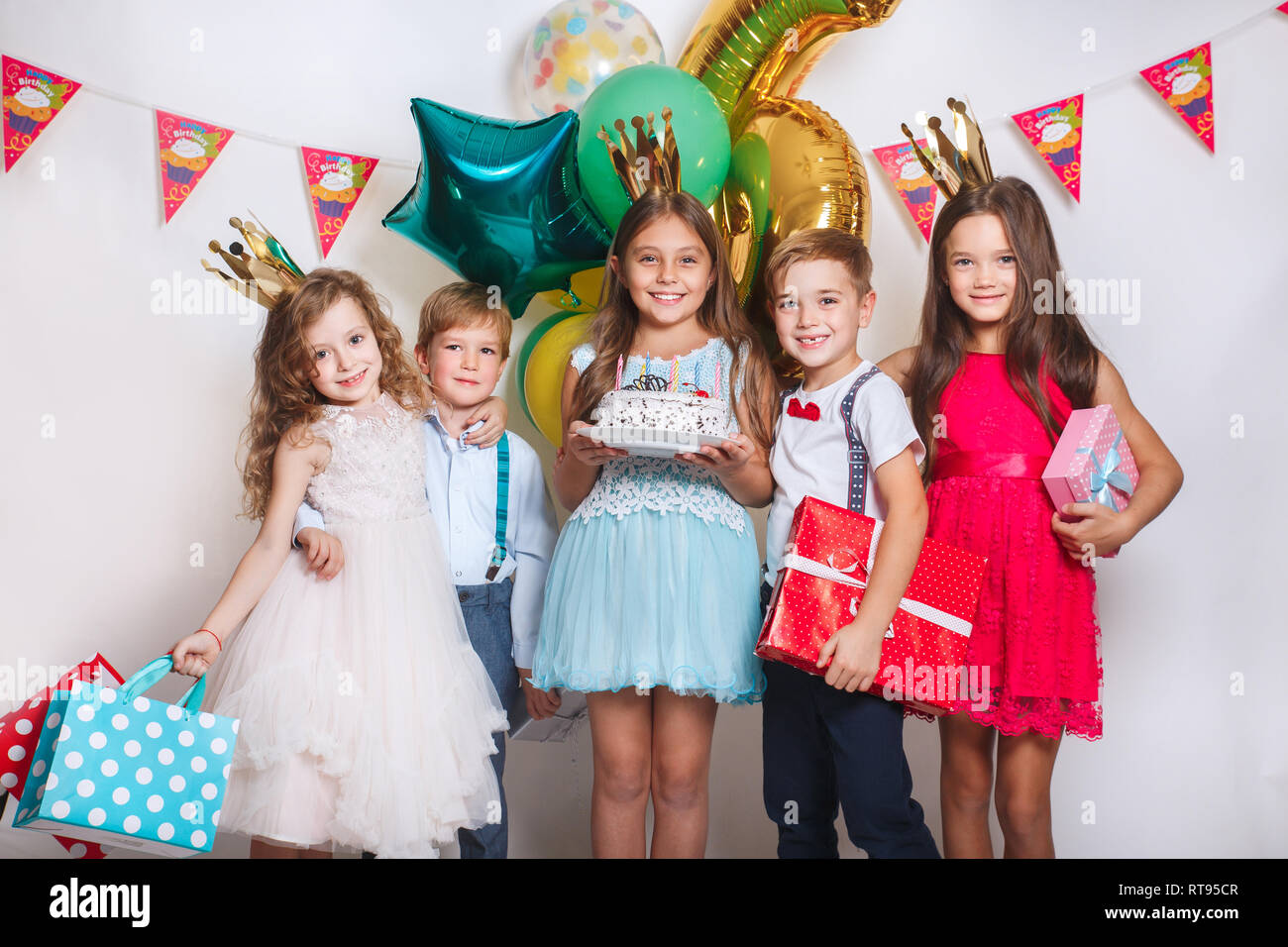Children's birthday. Happy kids with cake and gifts Stock Photo - Alamy