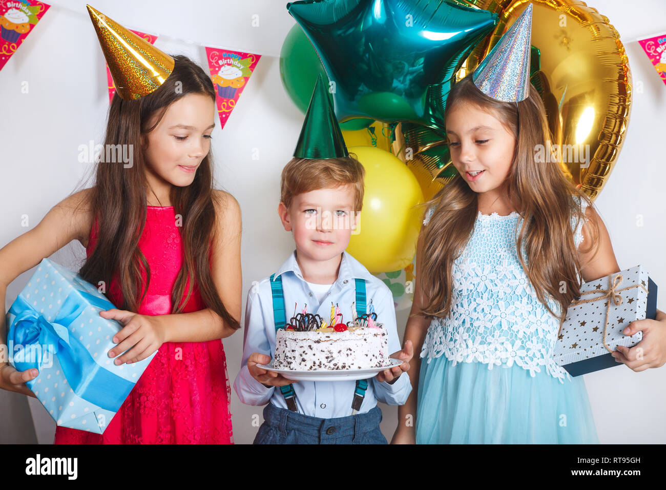 Children's birthday. Happy kids with cake and gifts Stock Photo - Alamy
