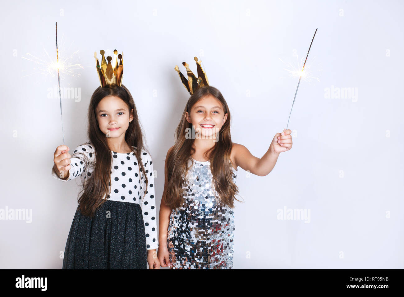 Two little girls playing with a sparkler on party Stock Photo - Alamy