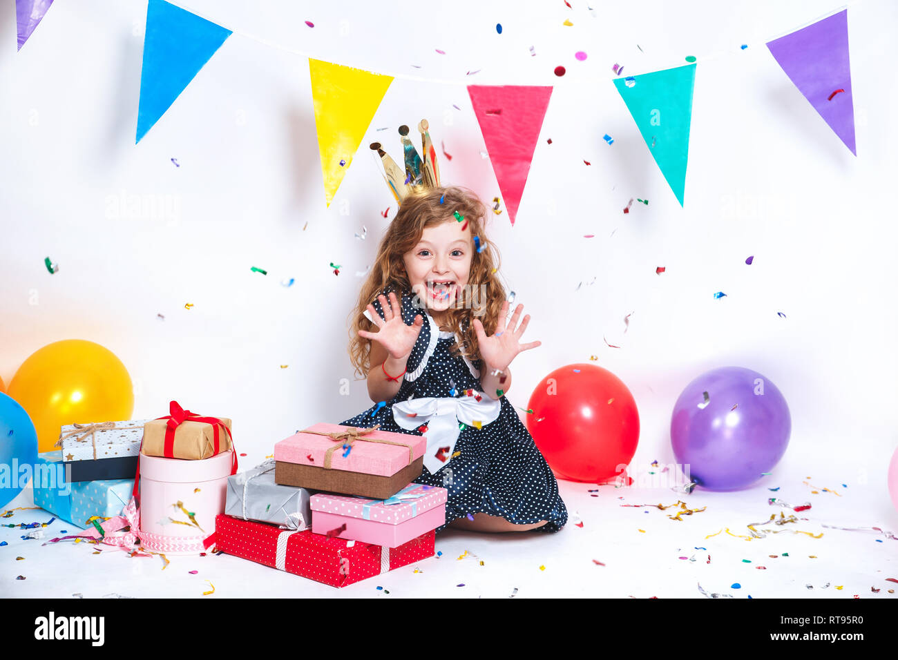 Birthday party for cute child. Little pretty girl throwing colorful ...