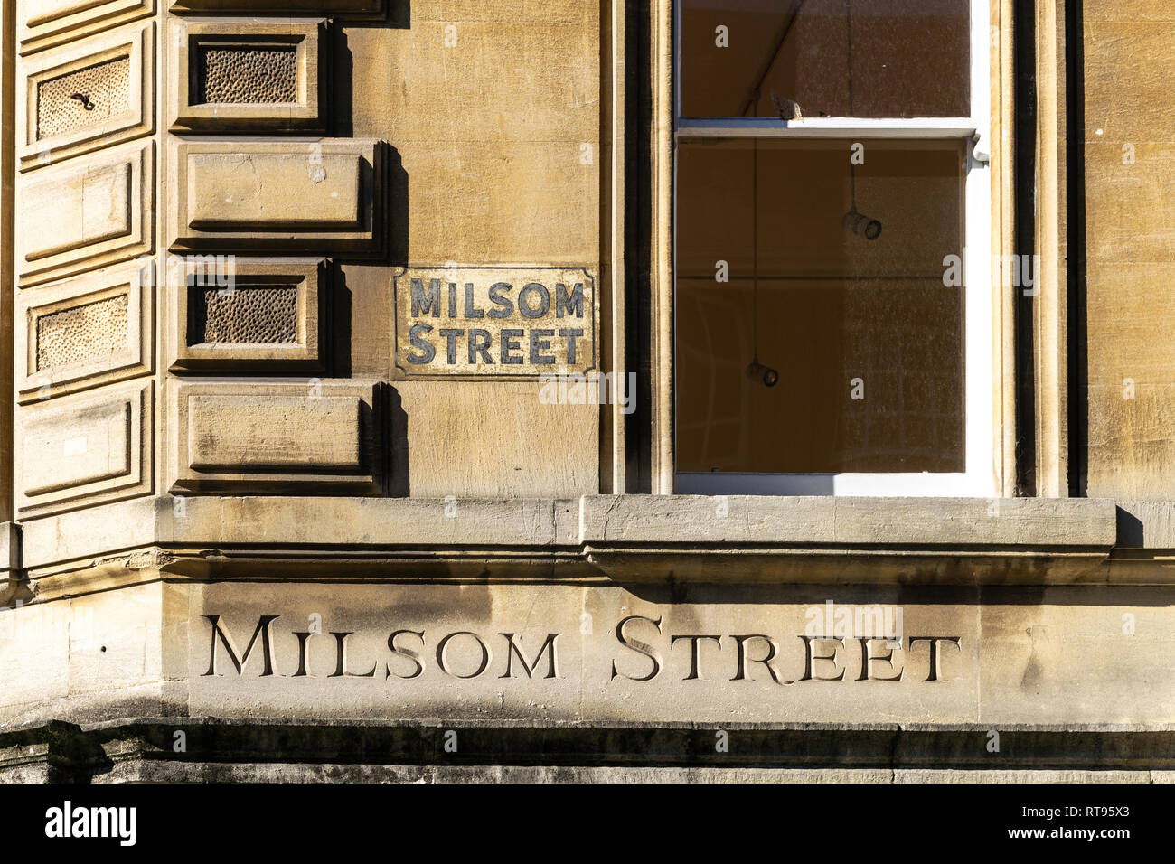 Two different versions of the Milsom Street sign above number 1 Milsom ...