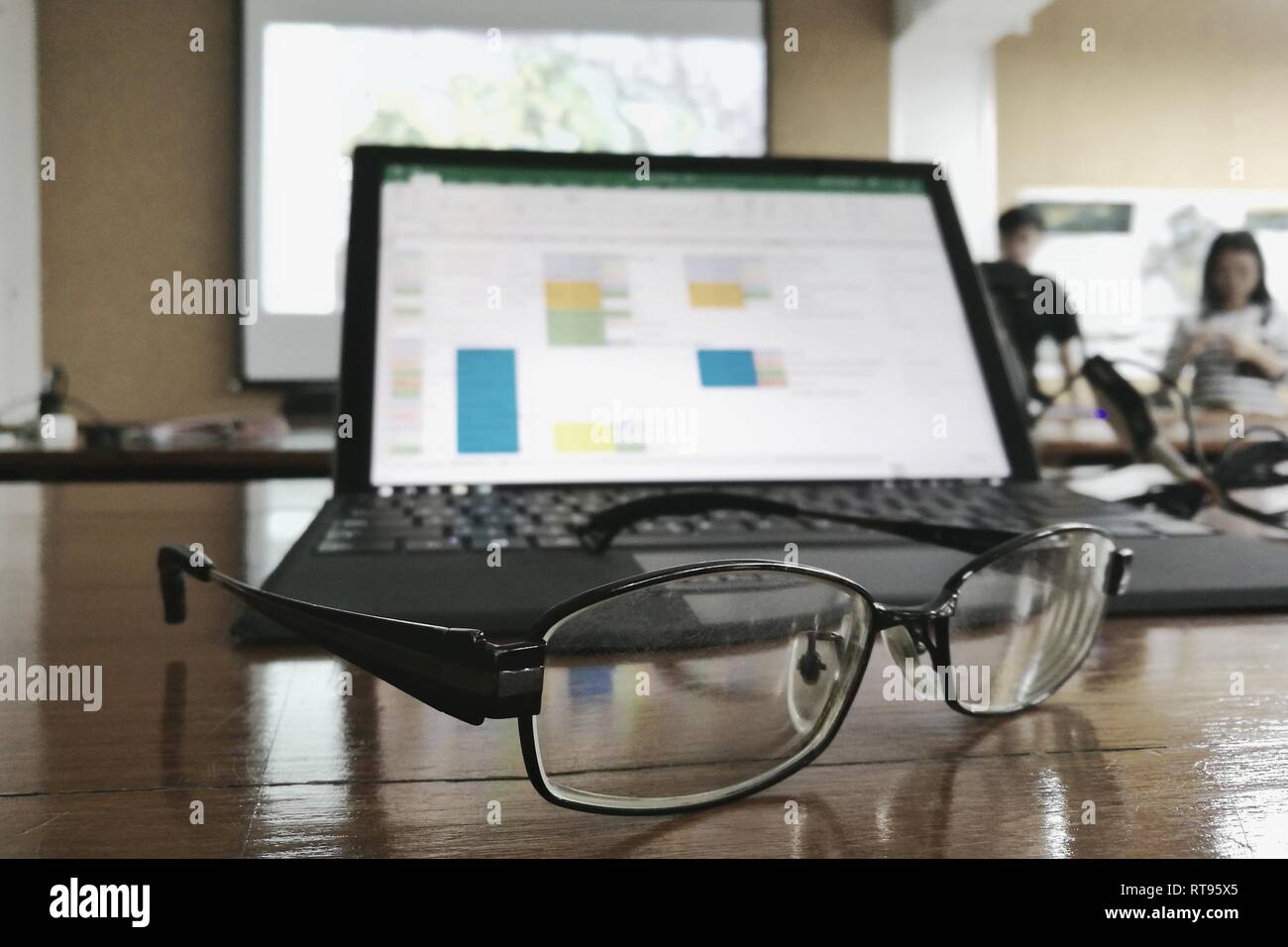 Tired and worn out in a meeting presentation. Glasses in front of a ...