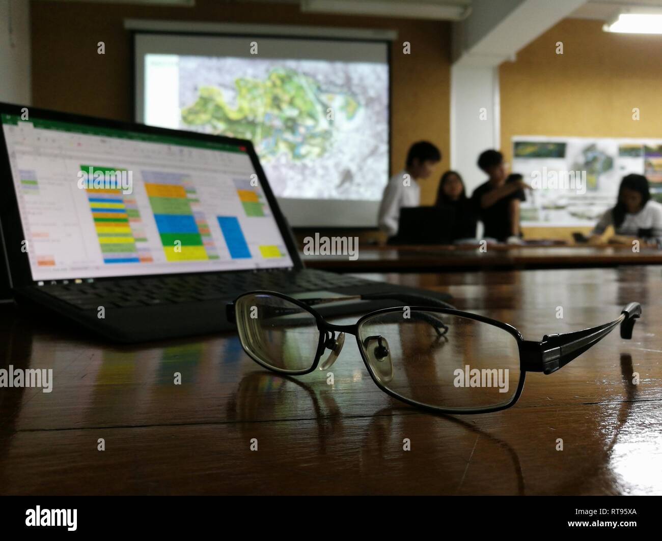 Tired and worn out in a meeting presentation. Glasses in front of a ...