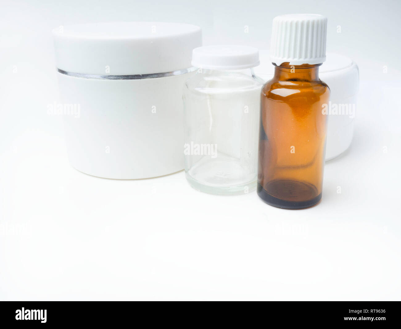 Realistic essential oil brown bottle and white jars Mock up bottle ...