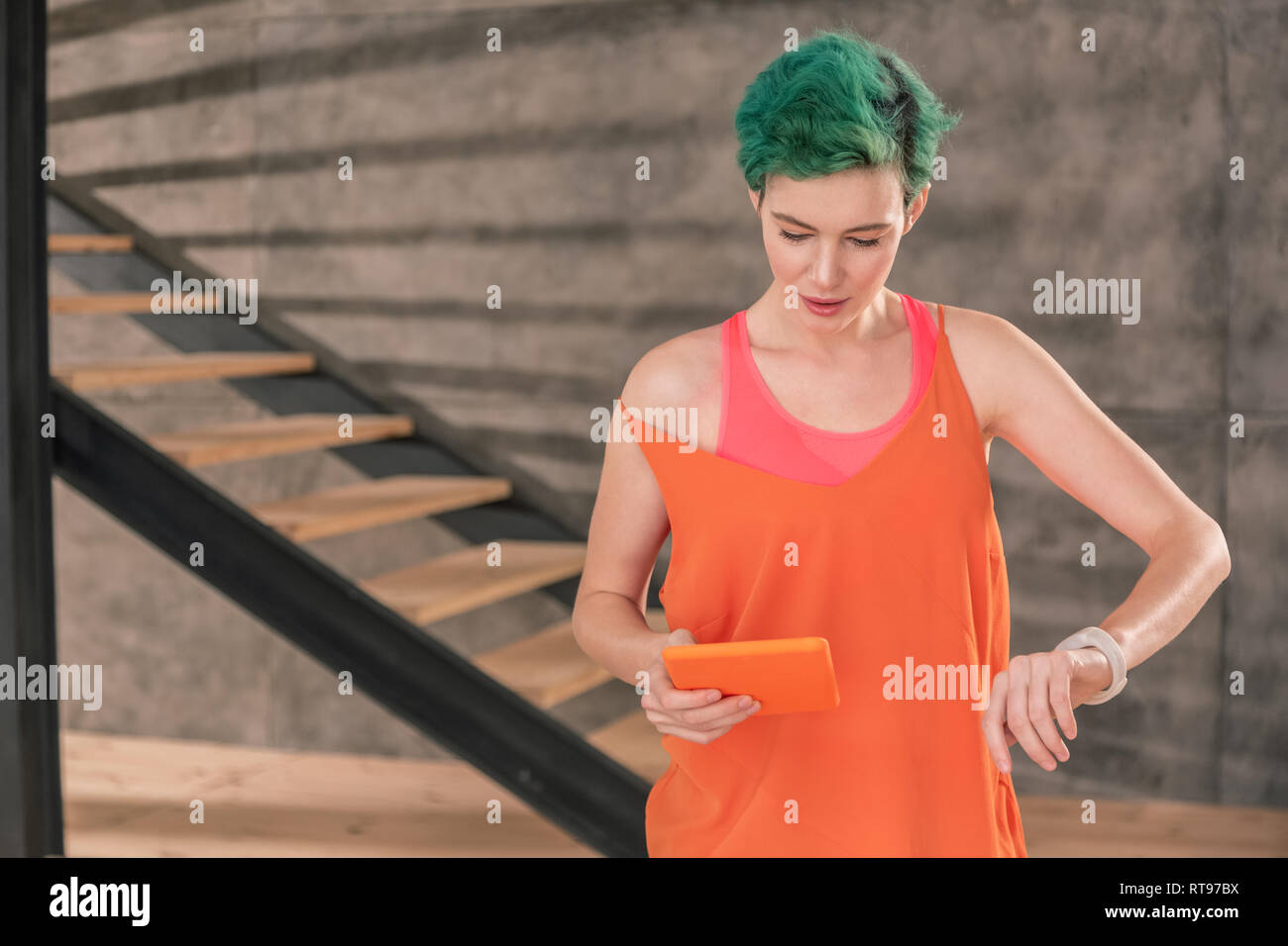Woman checking time on smart watch running late for work Stock Photo ...