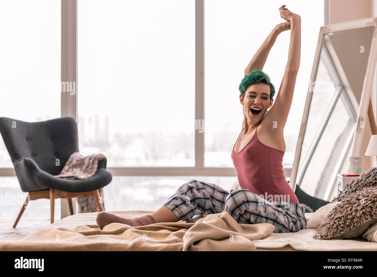 Woman yawning stretching in bed hi-res stock photography and images - Alamy
