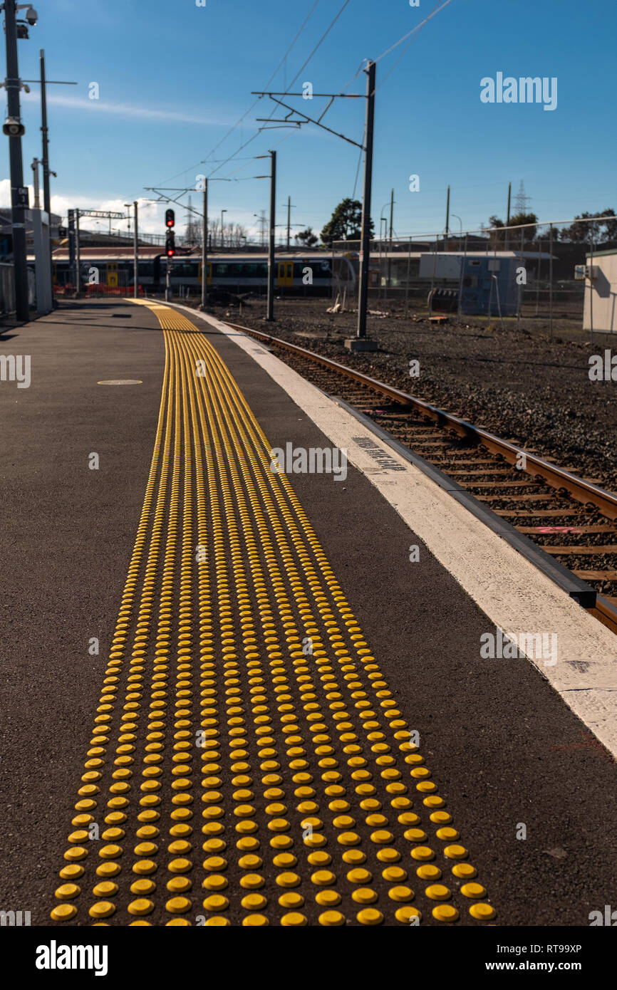 The mind gap warning on a platform at a train station, with yellow ...