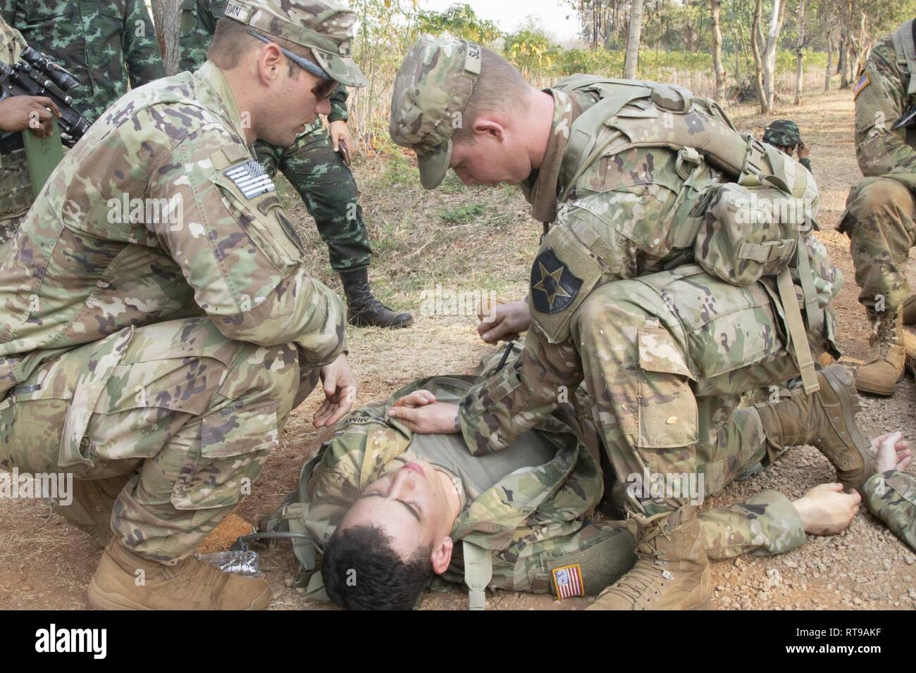 A Soldier (right) with 5th Battalion, 20th Infantry Regiment, treats a ...