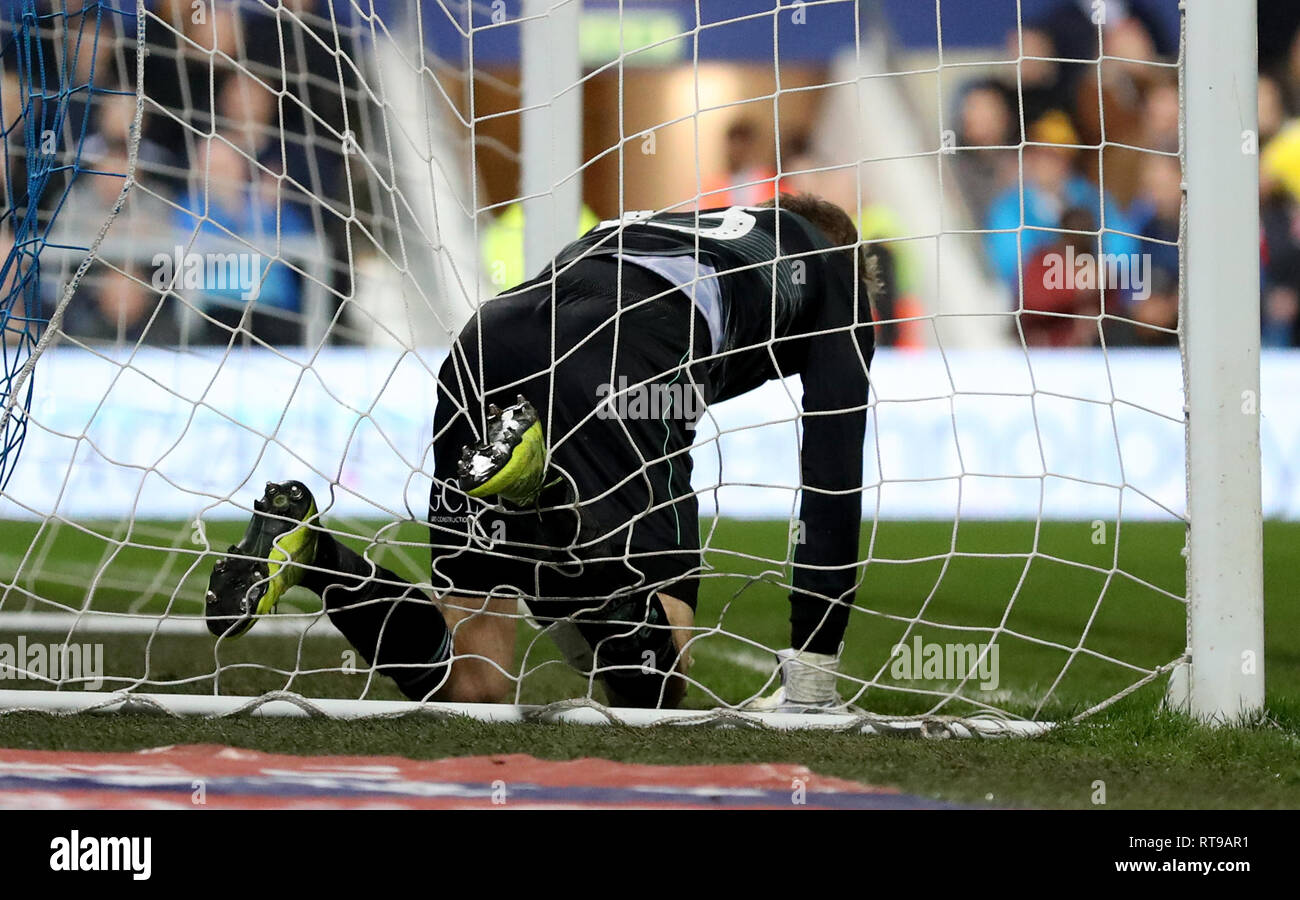 Queens Park Rangers goalkeeper Joe Lumley finds himself tangled in the ...