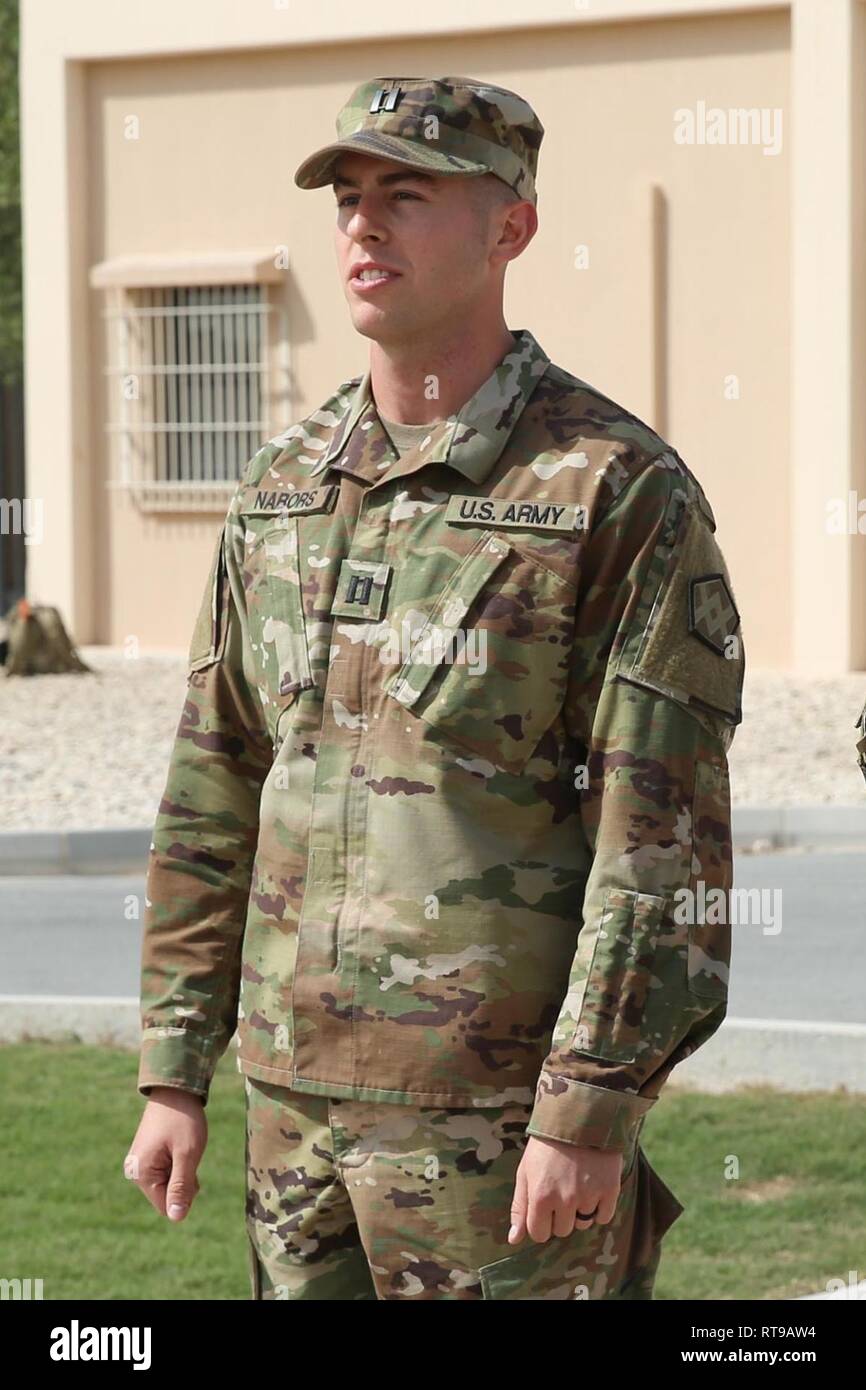 Capt. Derrick Nabors standing after being promoted at Camp As Sayliyah ...