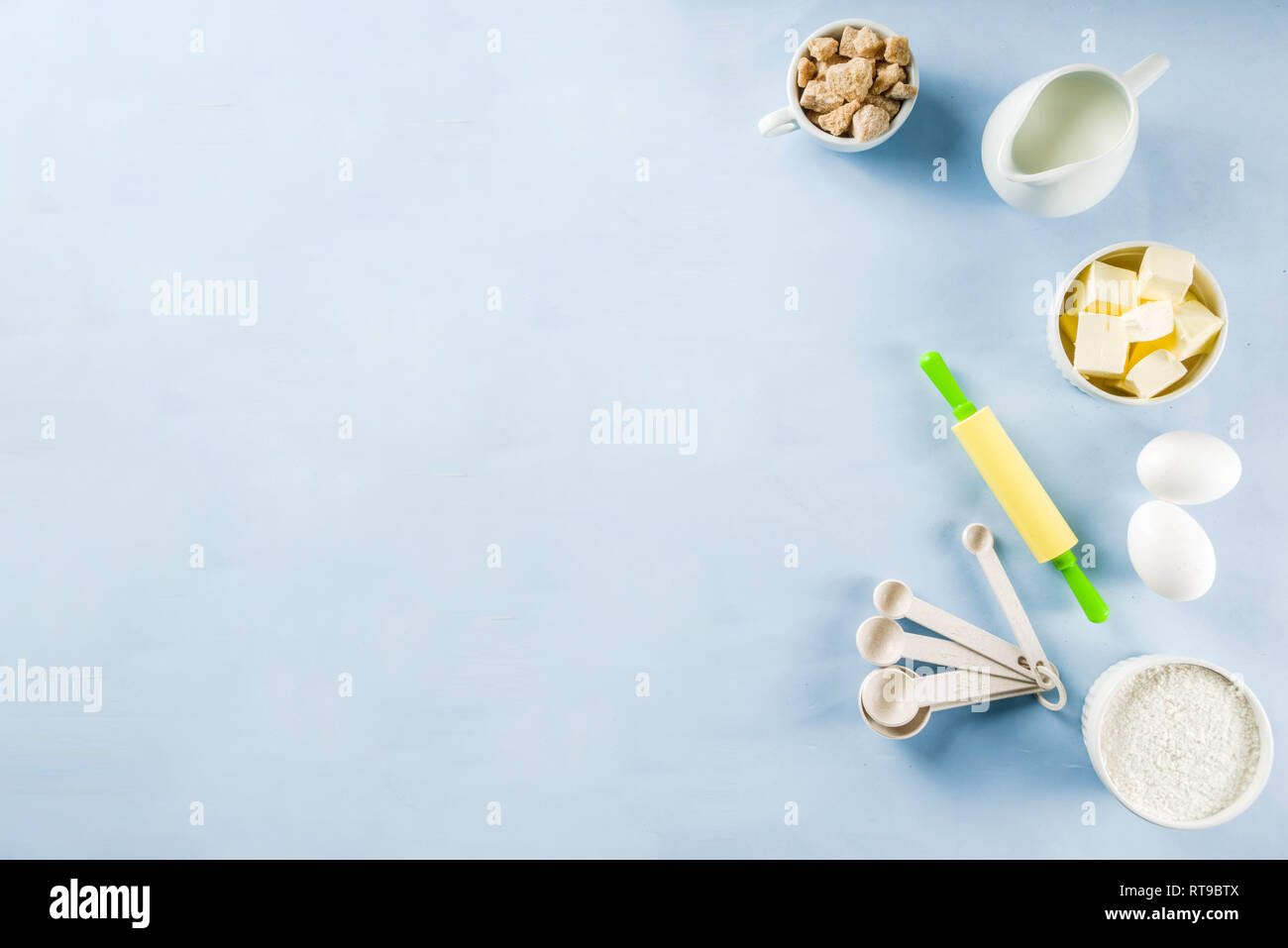 Baking ingredients and tools on trendy bright blue background - flour ...