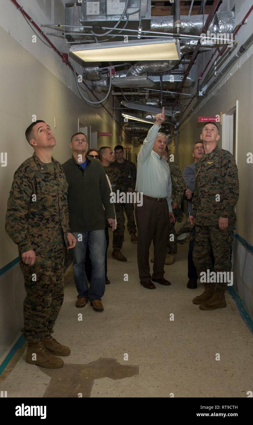 Distinguished guests assess damage to the interior of the II Marine ...